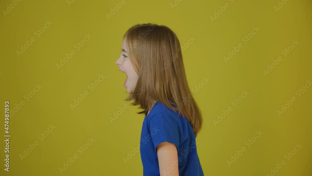 side view of a child shouting Loud. Portrait of shocked, Angry and emotional little girl. upset ...