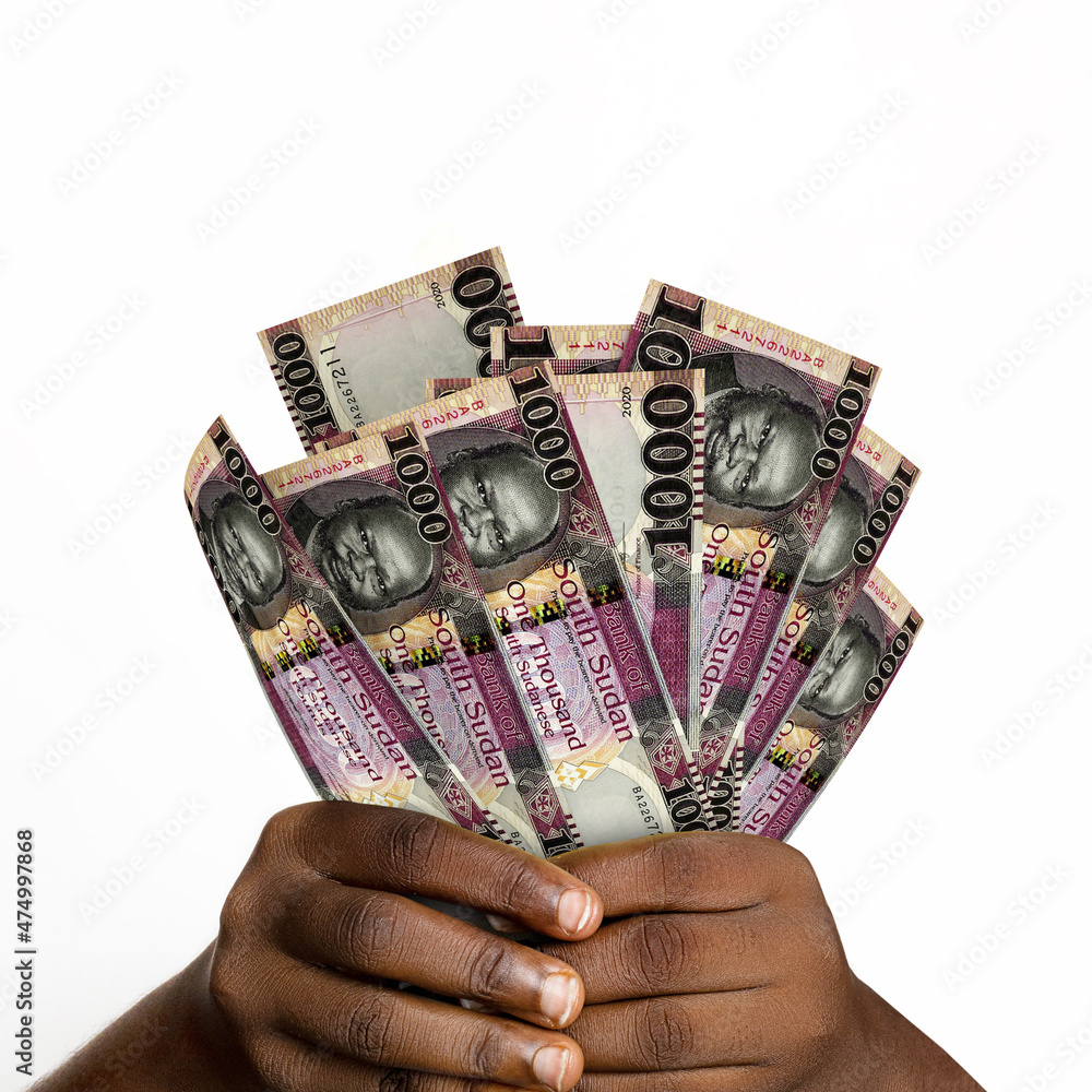 Black hands holding 3D rendered 1000 South Sudanese pound notes ...