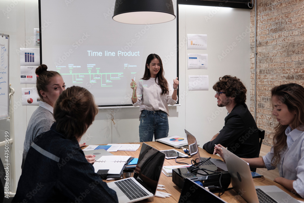 A cute Asian female staff standing and presenting business marketing ...