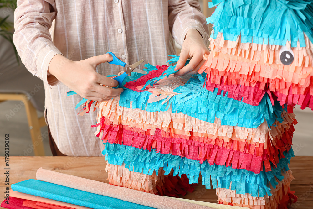 Woman making traditional Mexican pinata at table Stock Photo | Adobe Stock