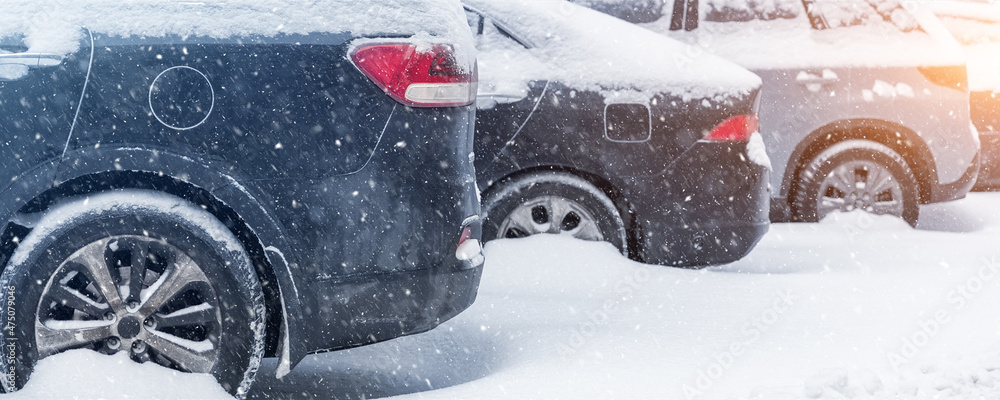 City street driveway parking lot with many cars covered by snow stucked ...