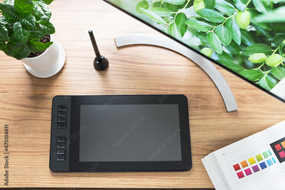 Design table from above. Top view of workspace with graphics tablet and ...