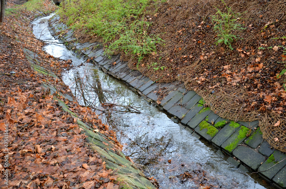 stream to cobbled into a narrow channel. the upper side is planted with ...