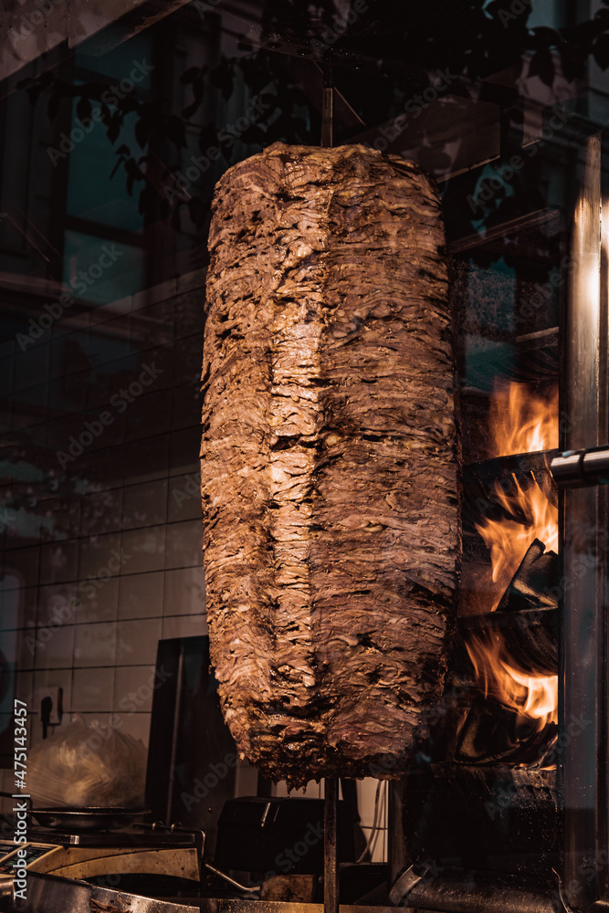 Shawarma meat being cut before making a sandwich. Delicious skewered ...