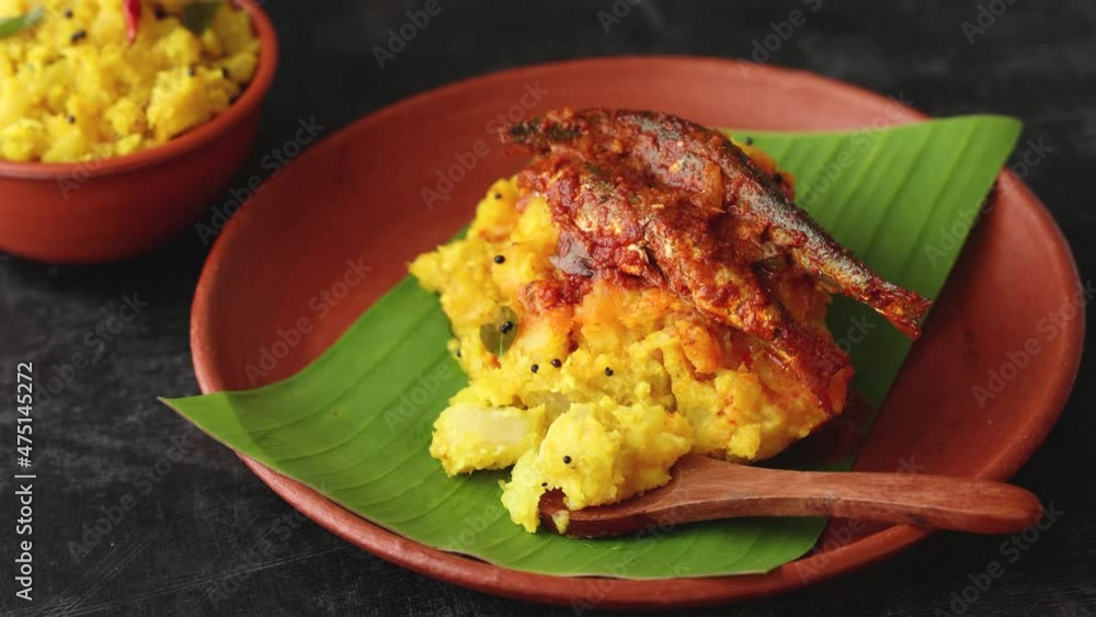 tapioca and spicy hot Kerala fish curry Indian food on banana leaf 4K ...