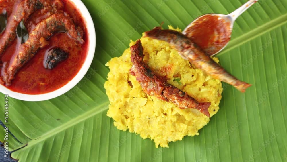 tapioca spicy hot Kerala fish curry woman hand serving Indian food ...