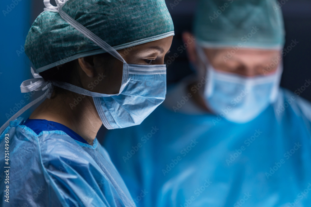 Multiracial team of professional medical surgeons performs the surgical ...