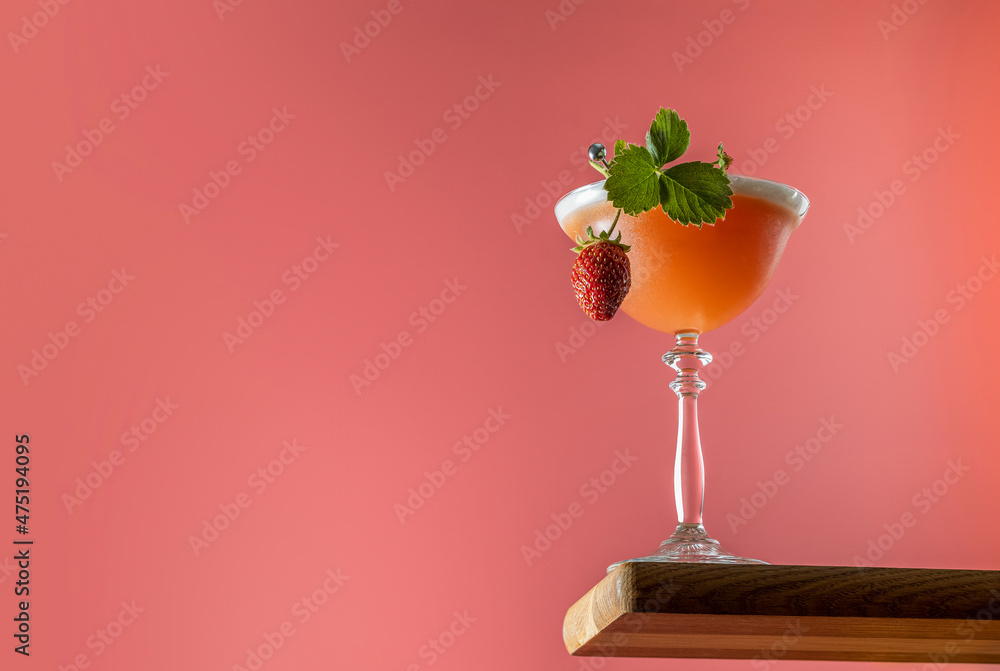 Sour drink with gin, strawberries, and egg white foam on bright pink ...