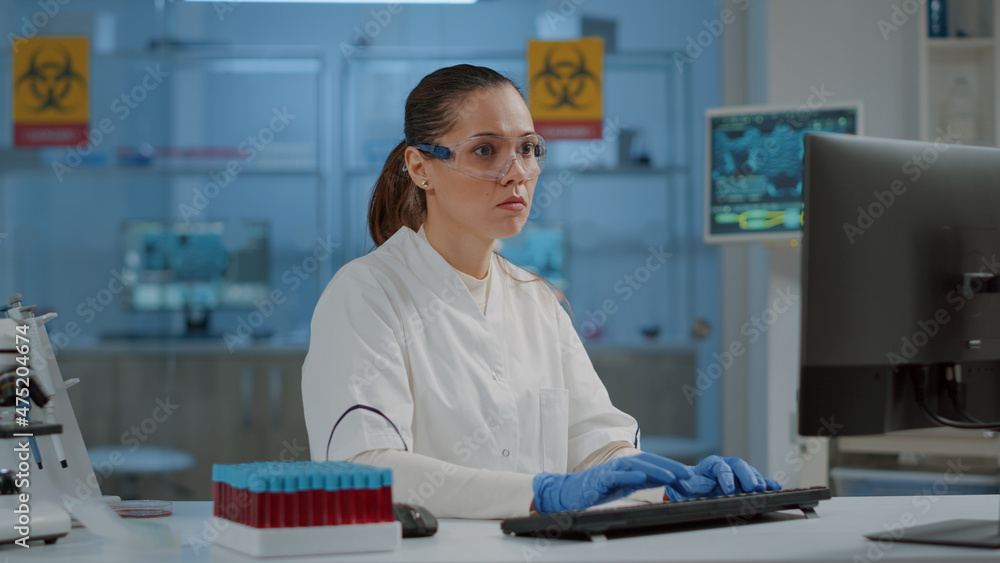 Science engineer using computer to work on chemistry experiment in ...