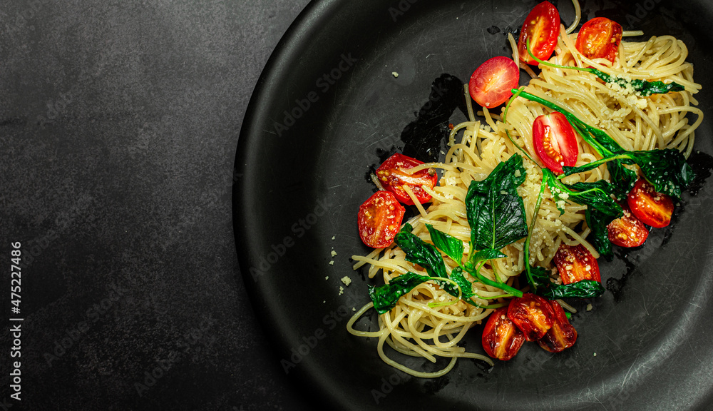 Tasty roasted garlic, seared tomato and wilted spinach pasta. Classic ...