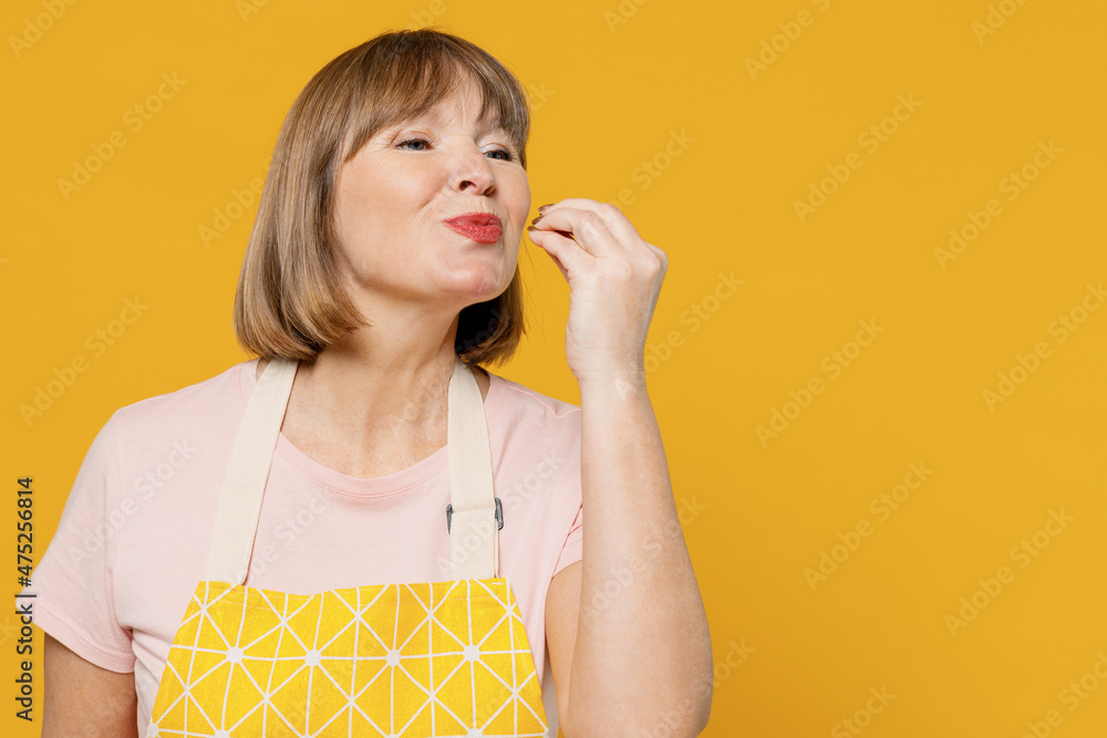 Elderly chef cooker housekeeper housewife woman 50s in orange apron ...