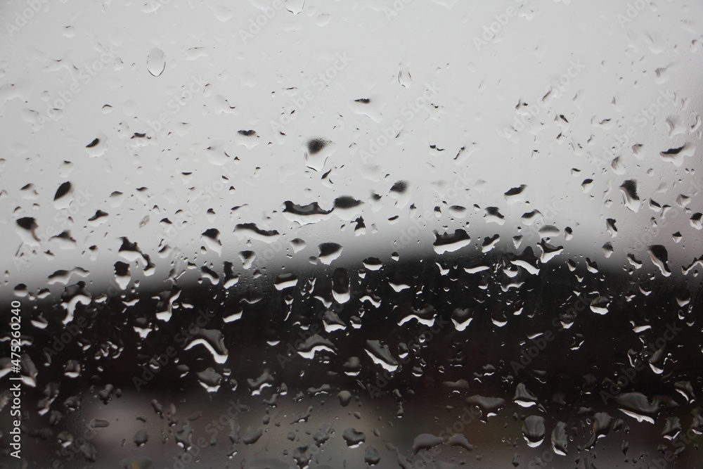 Contrast rain drops on transparent window glass at rainy autumn day on ...