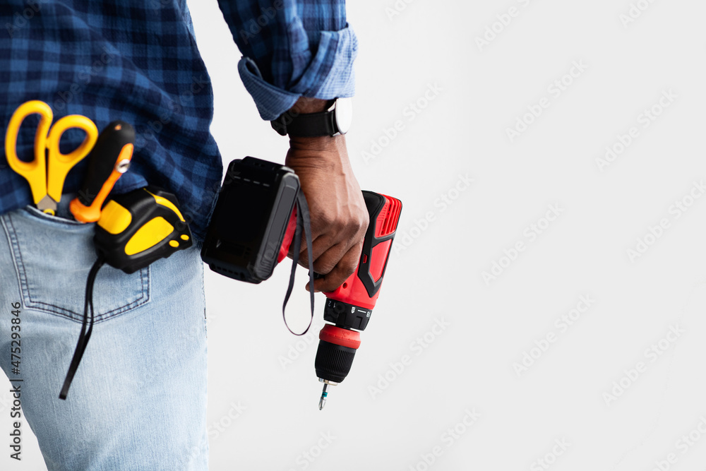 Men work concept. Black man holding screwdriver, with tools in pocket ...