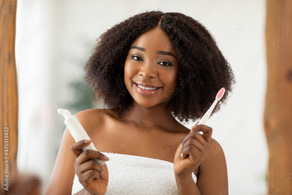 Dental care. Attractive young black woman with radiant smile holding ...