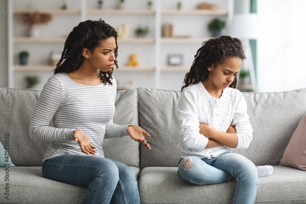 Angry mother scolding daughter, sitting on couch at home Stock Photo ...
