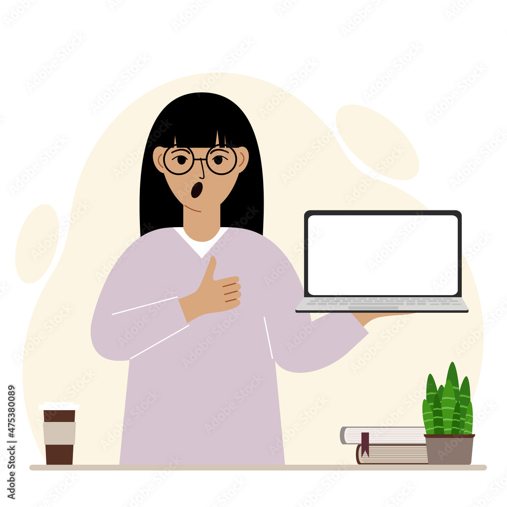 A woman holds a laptop computer on his hand and shows a thumbs up sign ...