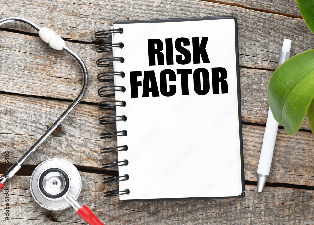 RISK FACTOR words written in an office notebook. Stock Photo | Adobe Stock