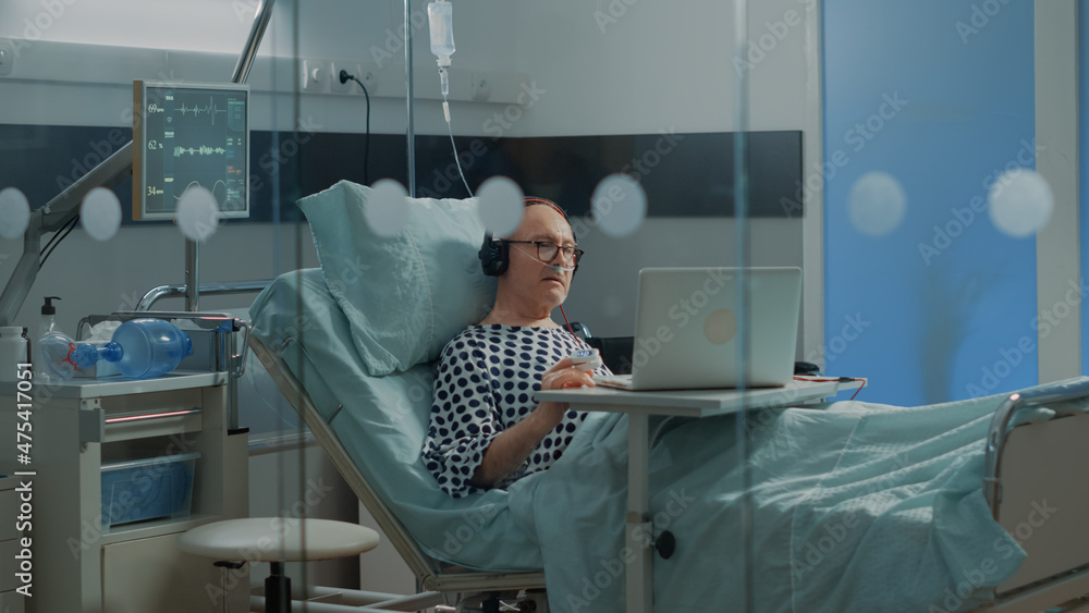 Hospital ward patient listening to music in intensive care room at ...