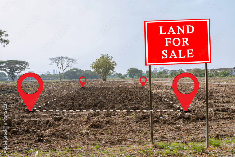 land for sale sign against trimmed lawn background. Empty dry cracked ...