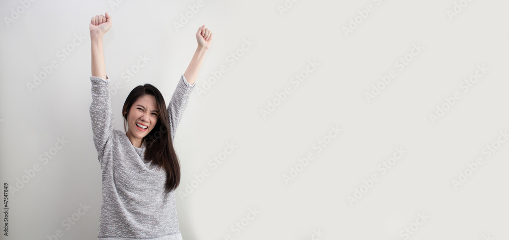Asian beautiful woman are raise both hand with smiling and happiness to ...