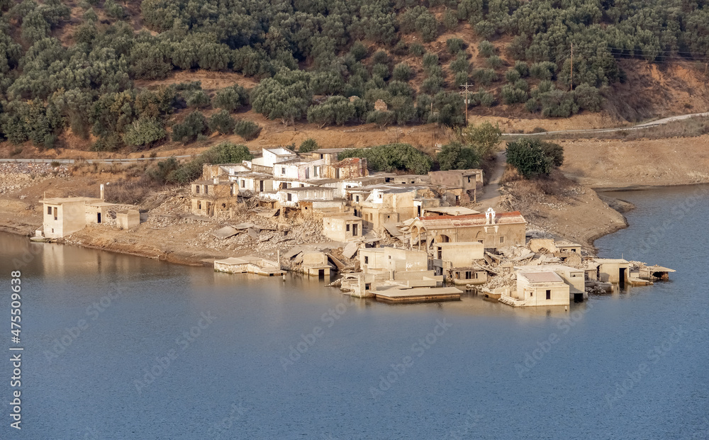 The flooded village of Sfendili on the shores of the Aposelemi Dam ...