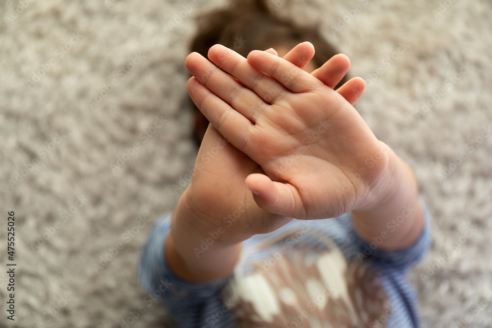 child showing stop gesture, stop bullying, violence, hands putting away ...