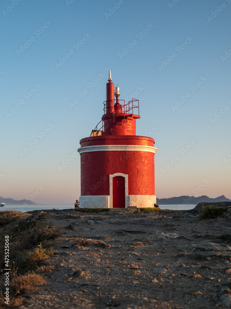 Beautiful view of a Punta Robaleira red lighthouse in Donon, Spain with ...