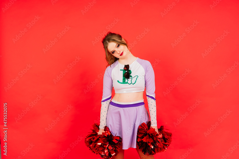 Beautiful young adult cheerleader female, studio red and blue ...