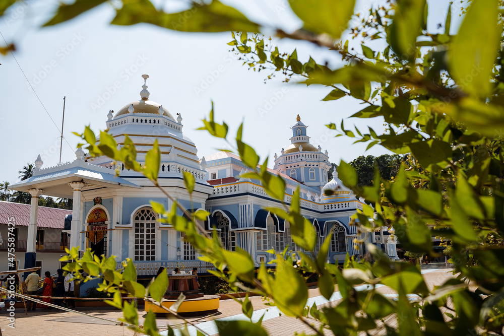 An Indian temple of blue color in clear weather. Goa pilgrim's journey ...