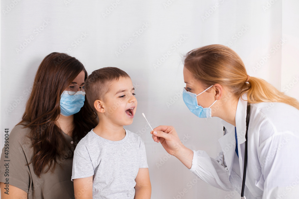 Covid 19 test by child. Doctor or nurse testing little boy for ...