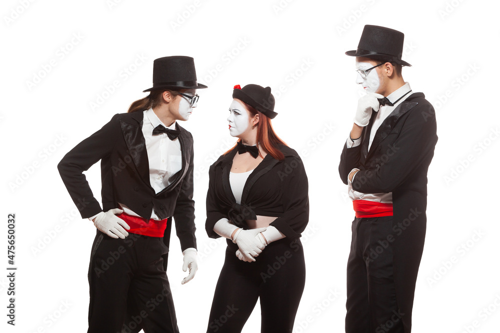 Portrait of three mime artists performing, isolated on white background ...