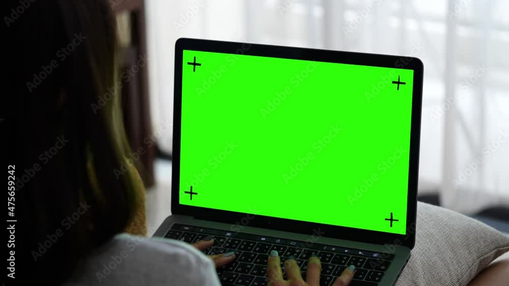 Woman scrolling computer screen. The screen is green for ready to use ...