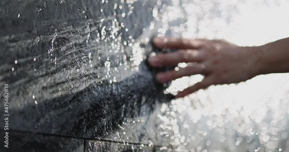 Wideo Stock: 4K Video slow motion hand touch water fall slowly on ...