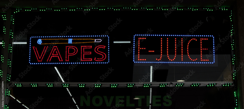 Vapes, e-Juice and Novelties Sign in Window of local smoke shop Stock ...