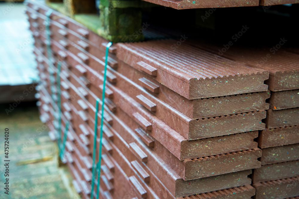 Pile of ribbed planks made from recycled plastic waste. Construction ...