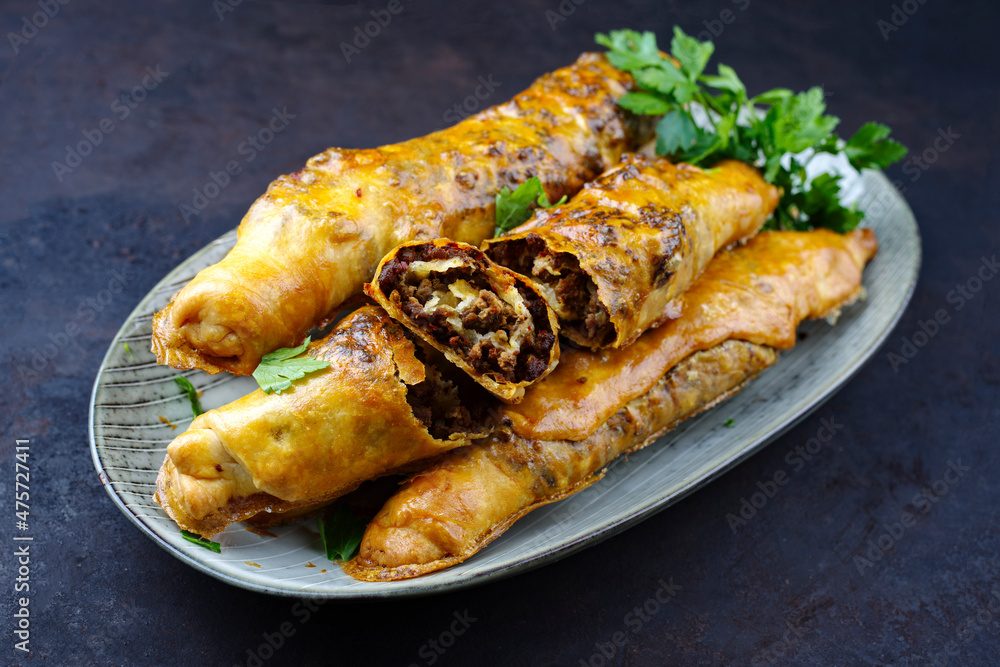 Traditional Turkish crispy sigara borek rolls with minced meat rolled ...
