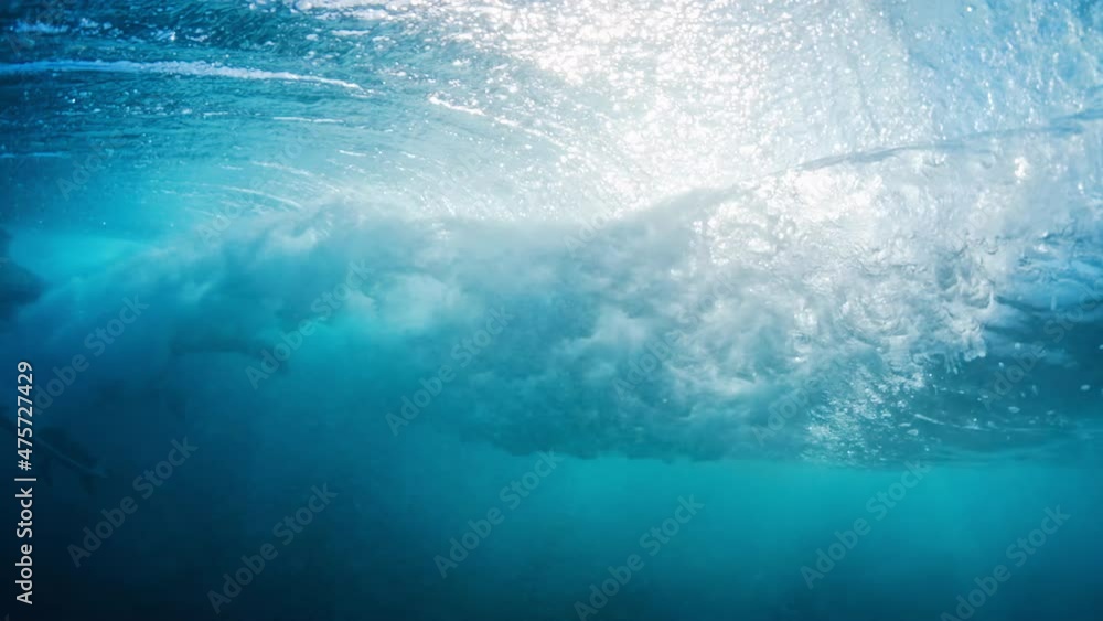 Ocean wave. Crystal clear ocean wave rolls and breaks with surfer ...