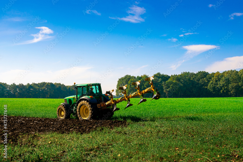 Tractor farm. Agriculture farm machinery on landscape land field ...