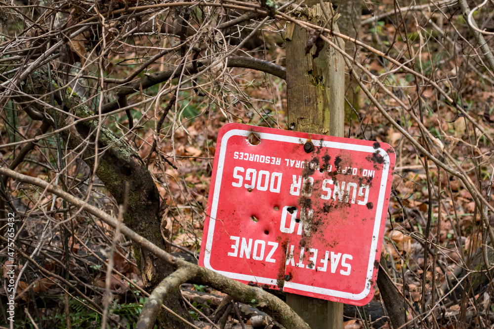 Irony on display in an upside down sign, stating no guns, but is ...