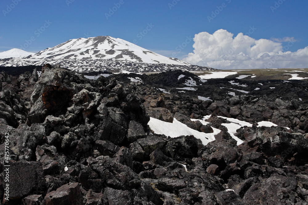 Snow-covered Mount Tendurek (Tondrak) shield volcano and lava flow in ...