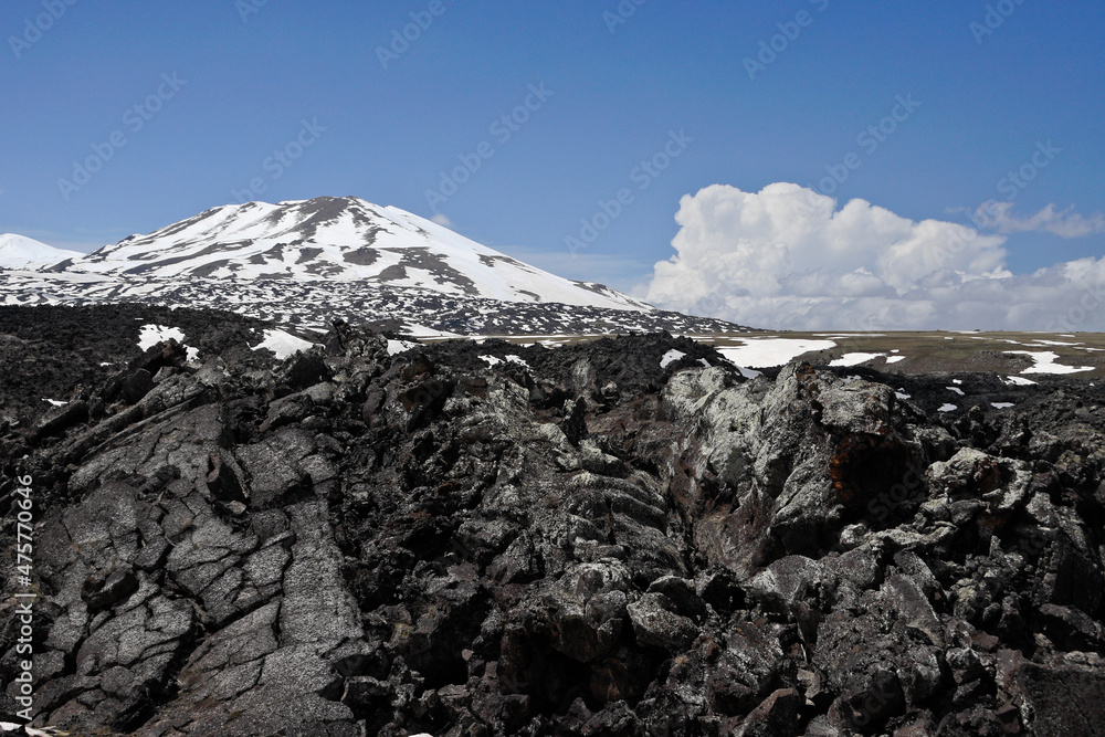 Snow-covered Mount Tendurek (Tondrak) shield volcano and lava flow in ...