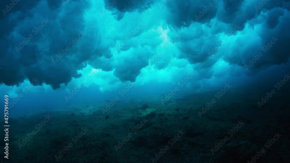 Ocean wave forms underwater clouds. Crystal clear ocean wave rolls and ...