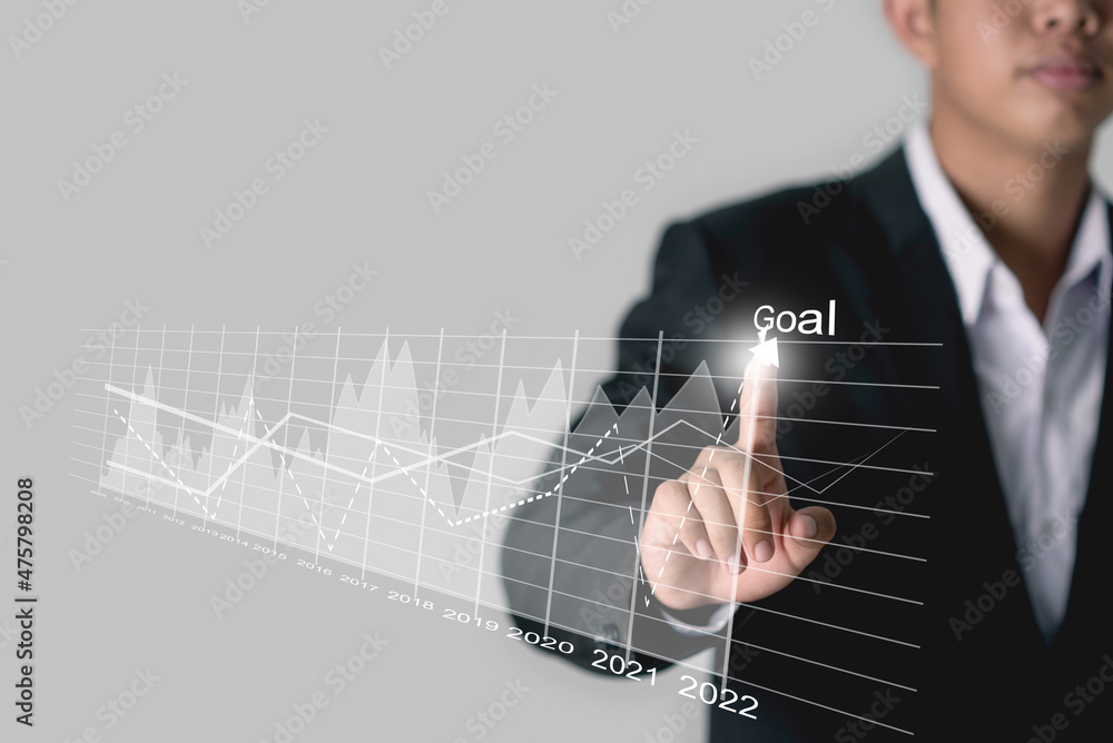 Businessman touching graph for showing goal in 2022 Customer ...