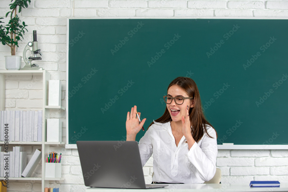 Female smiling student on lesson lecture in classroom at high school or ...
