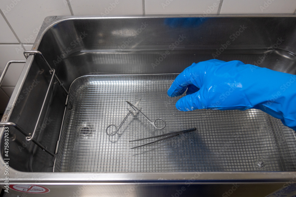 dirty instrument is placed in an ultrasonic basin Stock Photo | Adobe Stock
