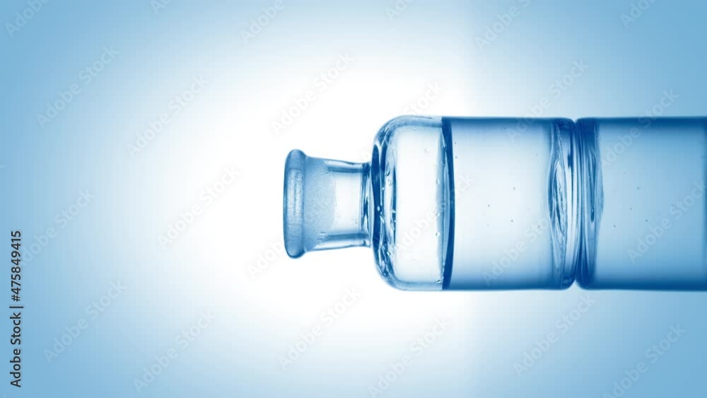 Blue drop is falling into old fashioned bottle with blue transparent ...