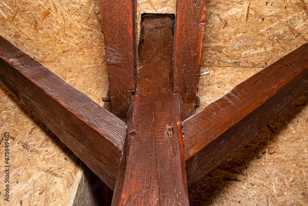 Roof truss visible in the attic house, painted brown with visible ...