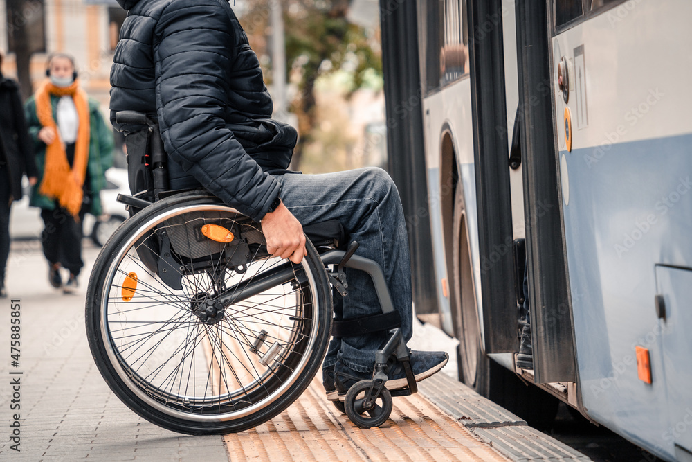 Person with a physical disability enters public transport with an ...