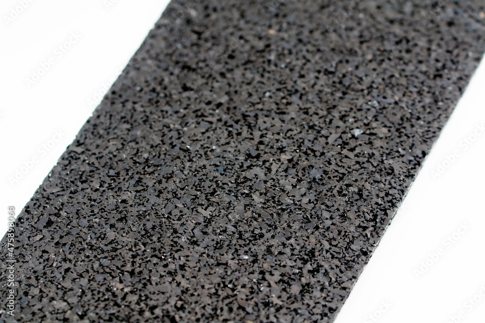 Granular rubber detail in front of a white background. Recycle rubber ...