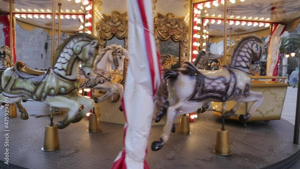 Carousel with galloping horses at amusement park or fairground ...